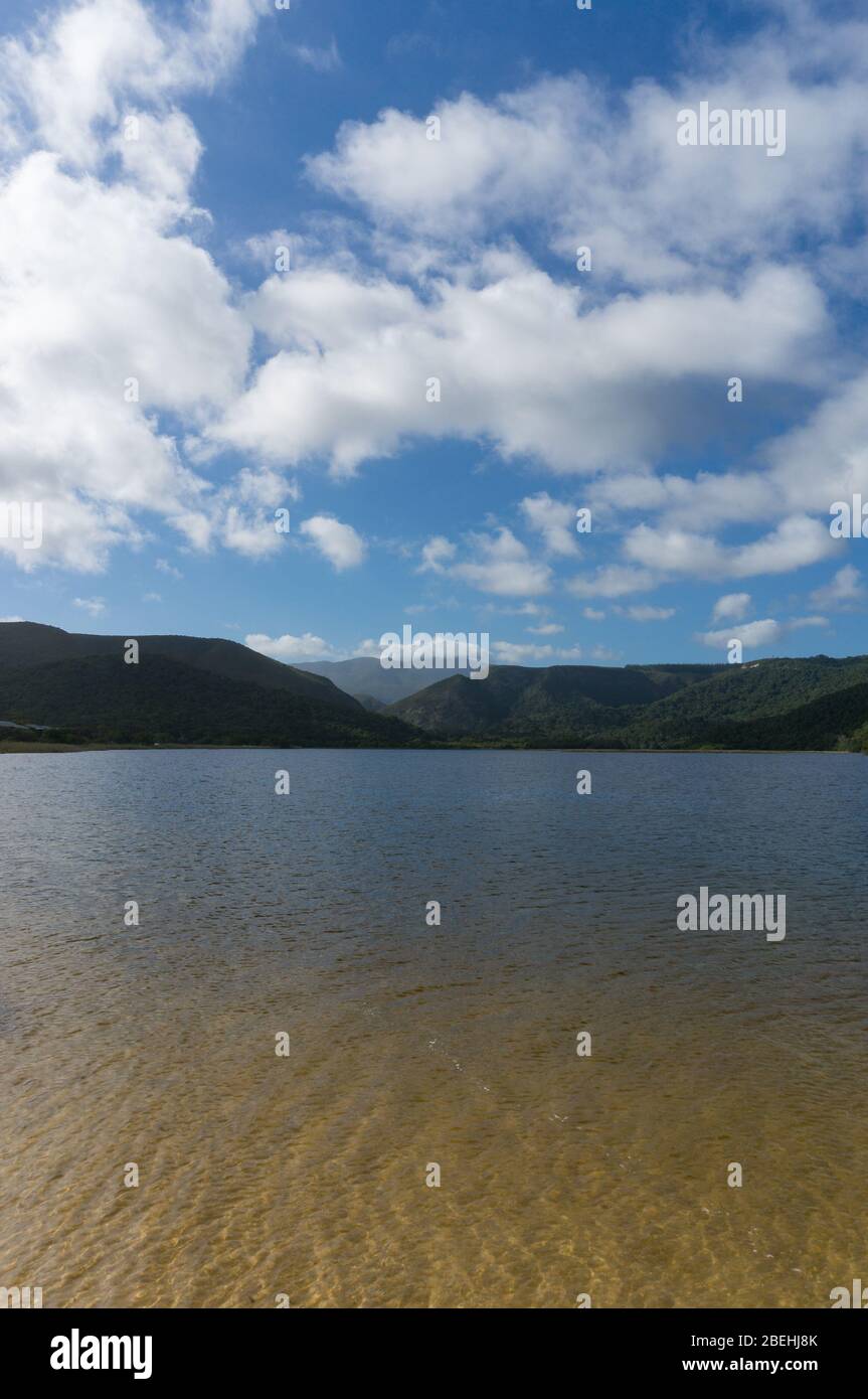 Pristine nature landscape of clear water and forest covered mountains ...