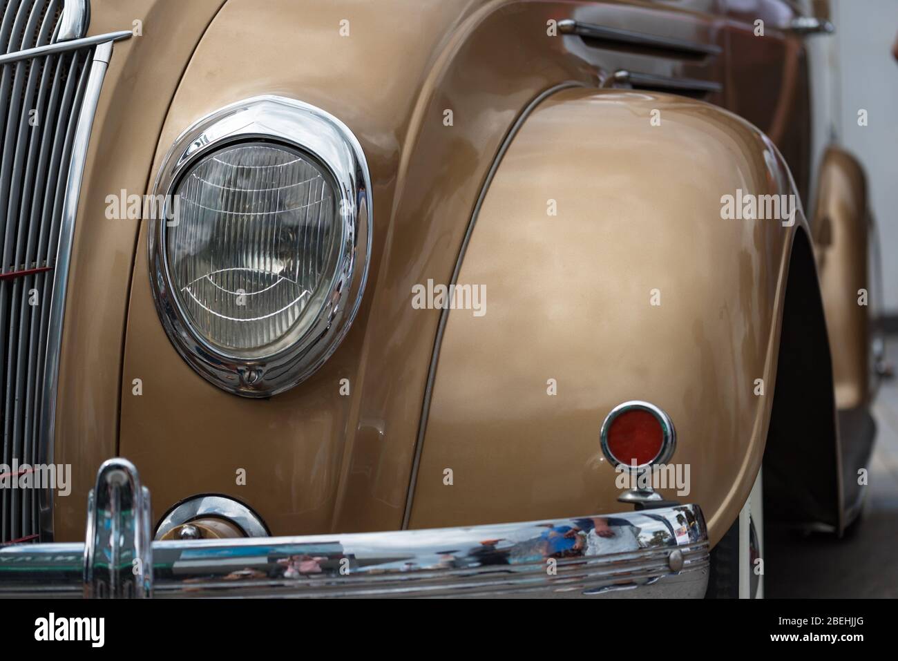 Shiny golden vintage car front and headlight. Classic car model Stock ...