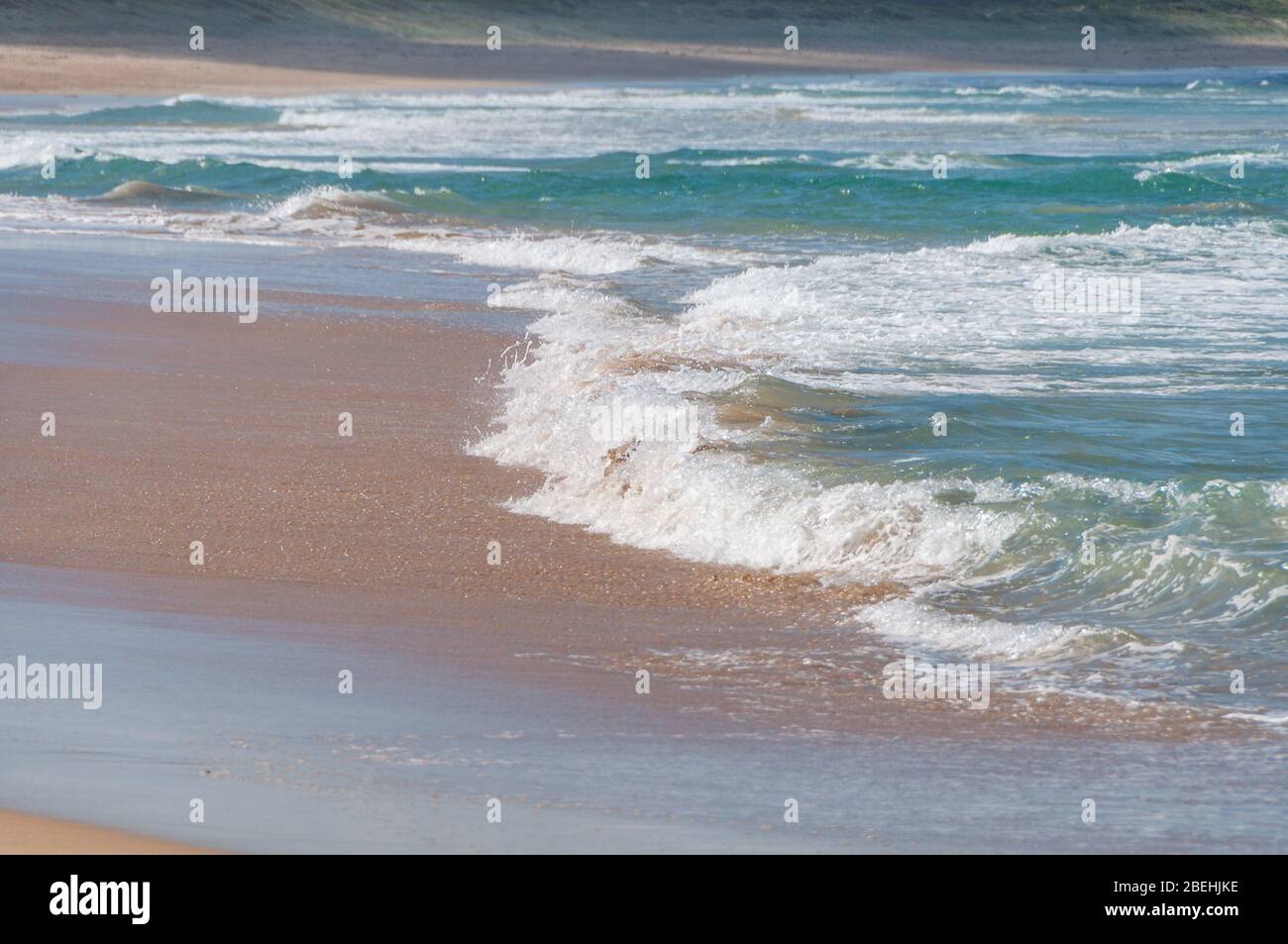 Beautiful sandy beach background with mild waves. Summer vacation scene ...
