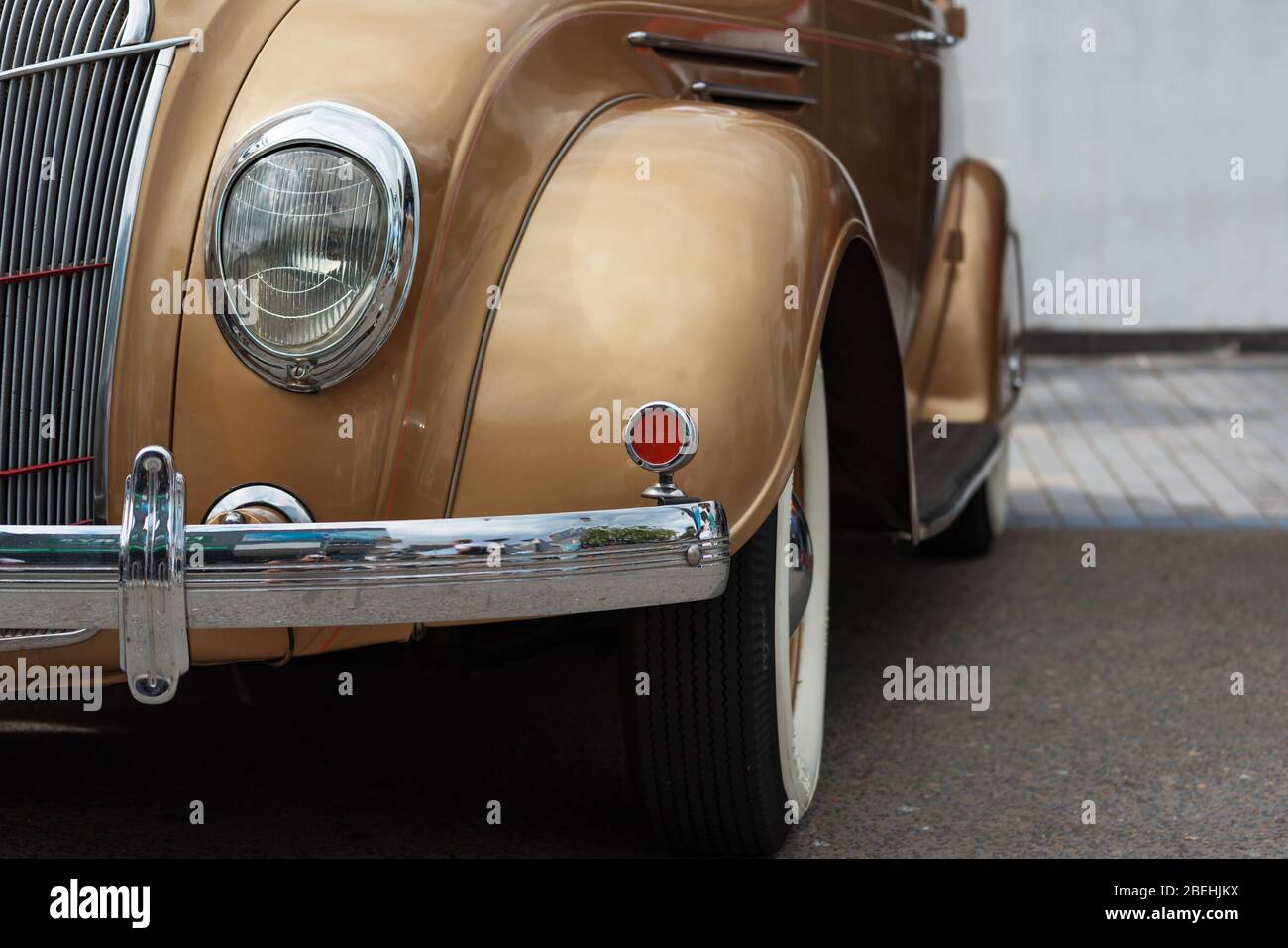 Shiny golden vintage car front and headlight. Classic car model Stock ...