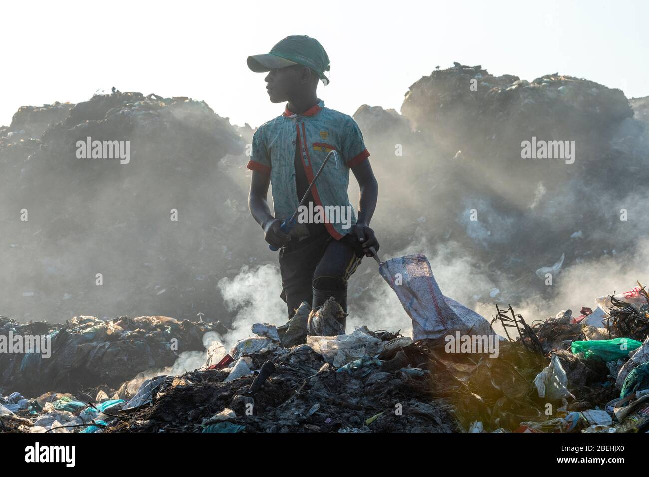 Boy With A Hook And A Bag Sorting Garbage in a Garbage Dump near Sylhet ...