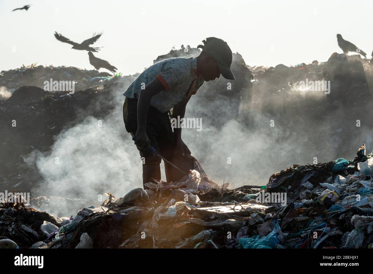 Boy With A Hook And A Bag Sorting Garbage in a Garbage Dump near Sylhet ...