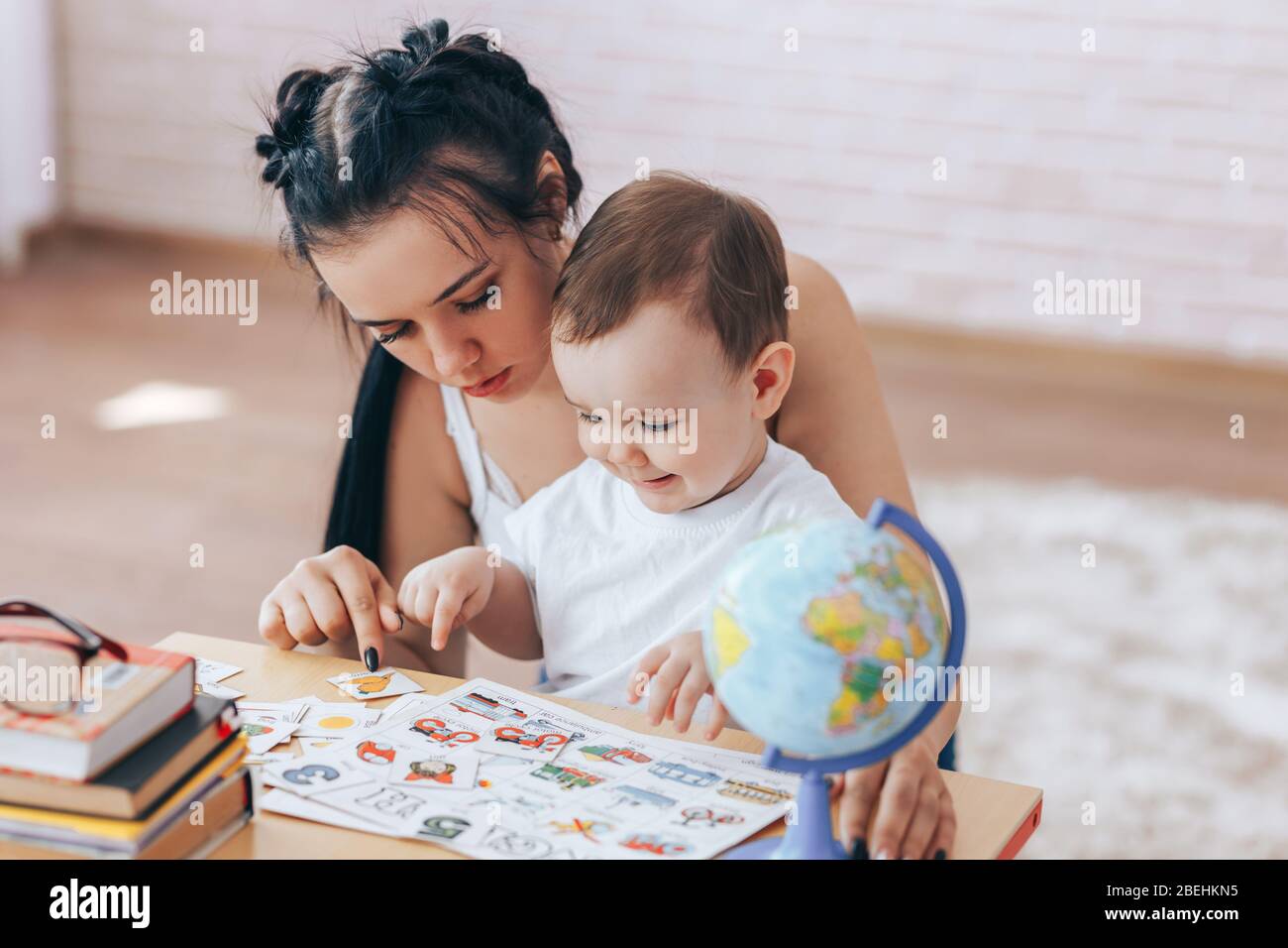 Teaching children with parents Stock Photo - Alamy