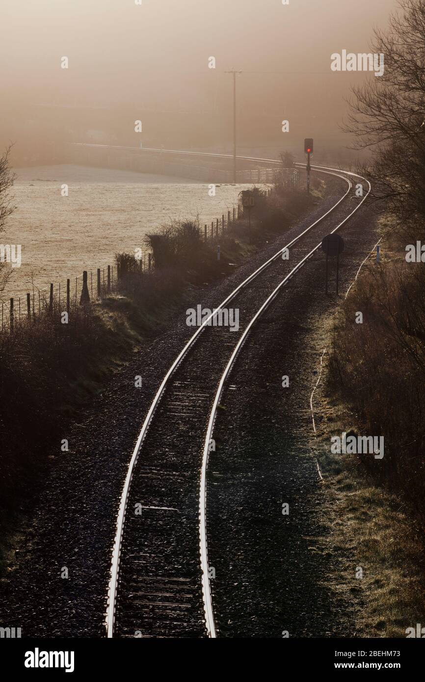 Winding single track rural railway line on a misty morning at Park ...
