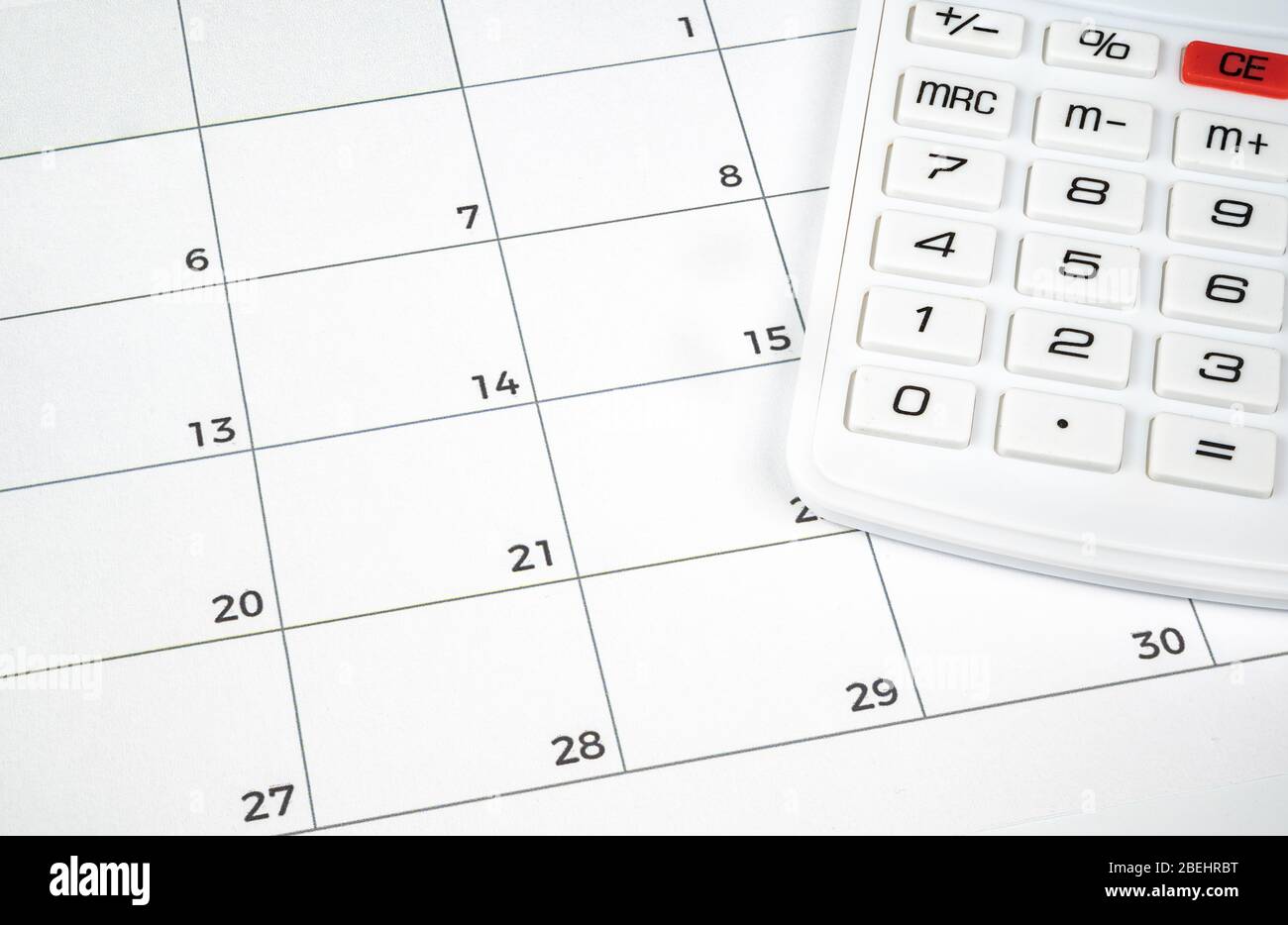 A financial concept with a calculator on the calendar Stock Photo - Alamy