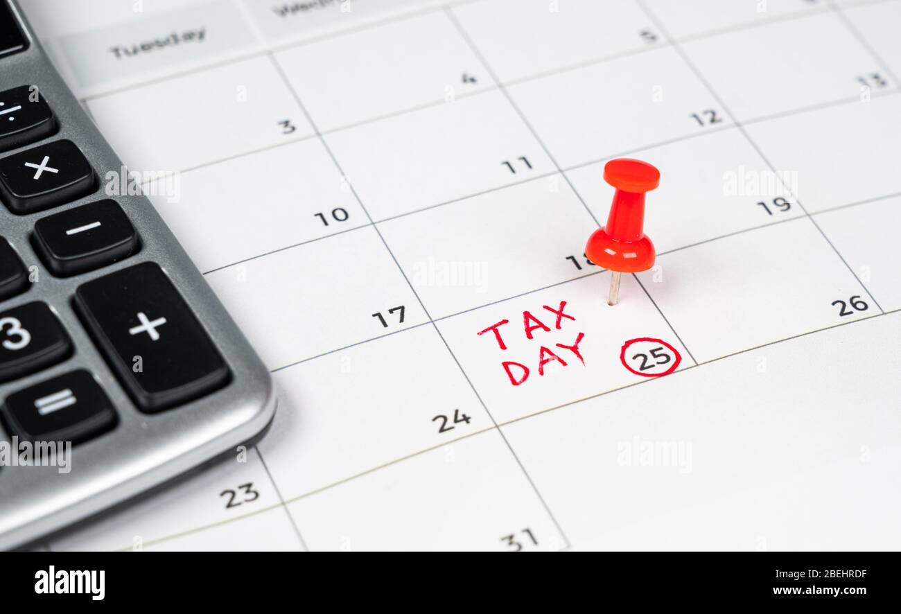 Tax day written on a calendar with a red pushpin Stock Photo - Alamy