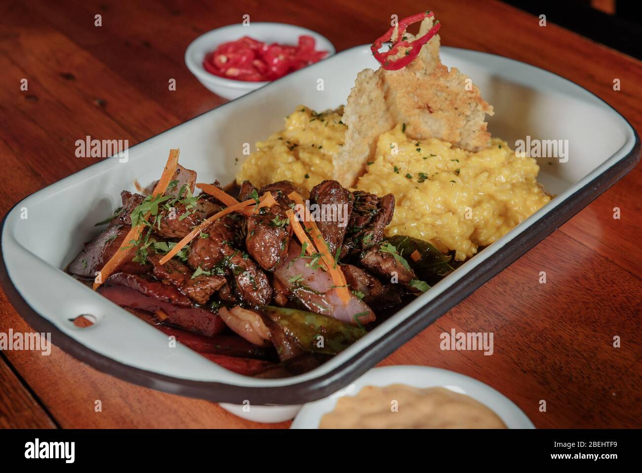 Peruvian food lomo saltado :A salted beef with tomatoes, onion, fried ...