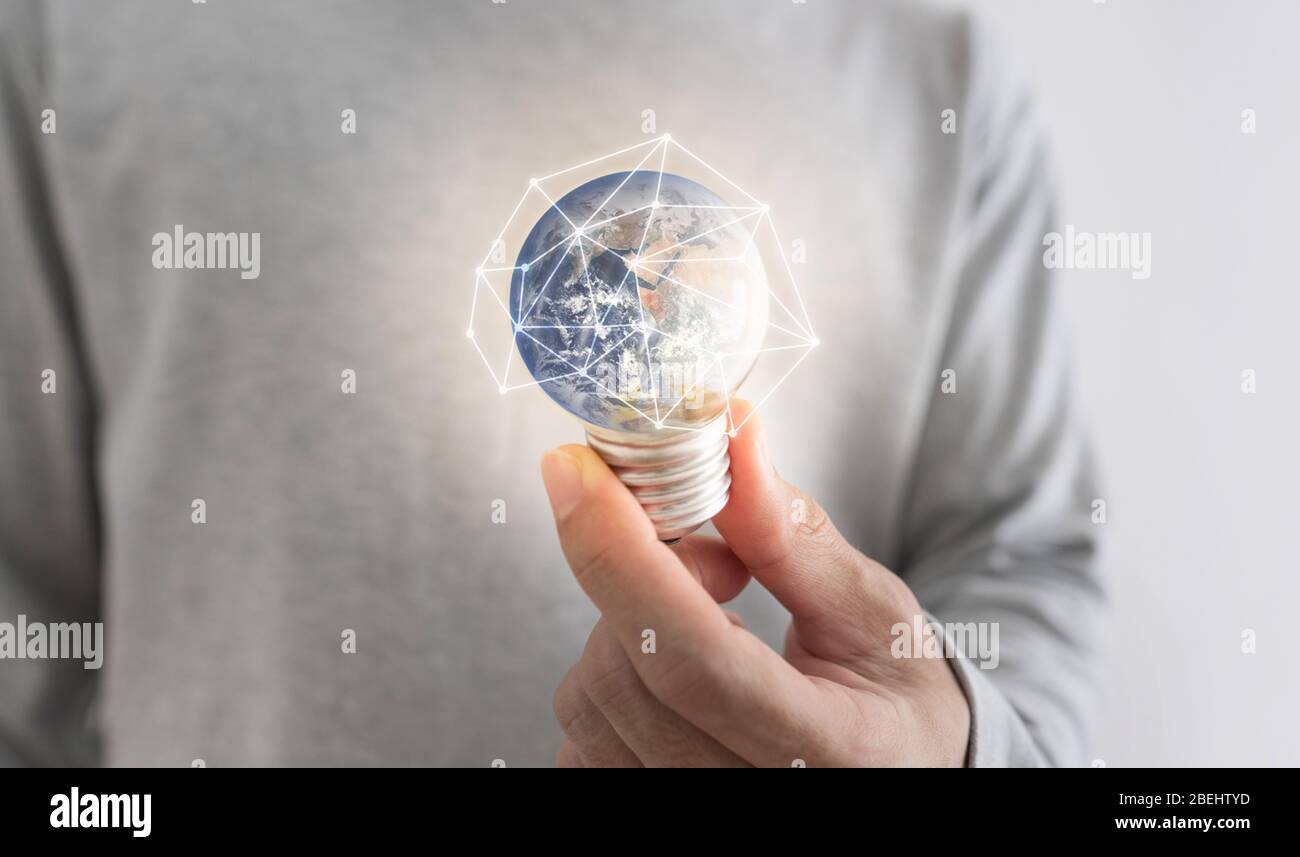 Saving energy, and earth day concept. a man holding glowing earth light ...
