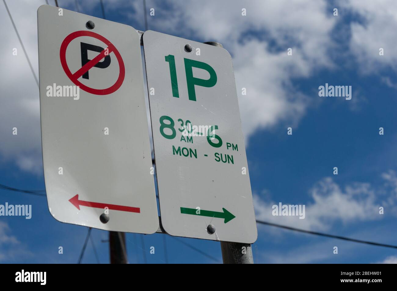 Parking sign indicating parking rules on both sides of the street Stock ...