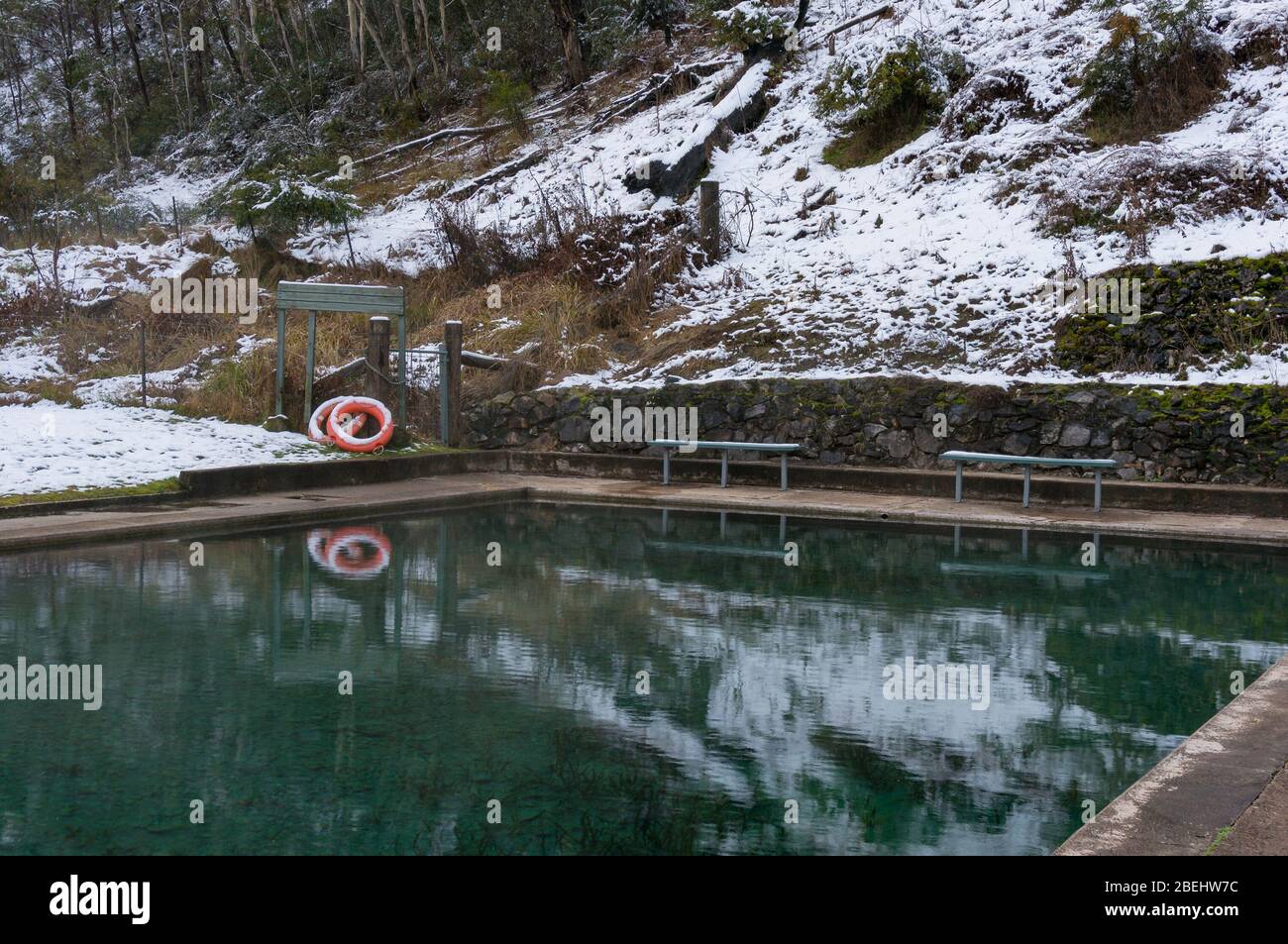 Outdoor swimming pool with winter landscape and snow. Yarrongobilly hot ...