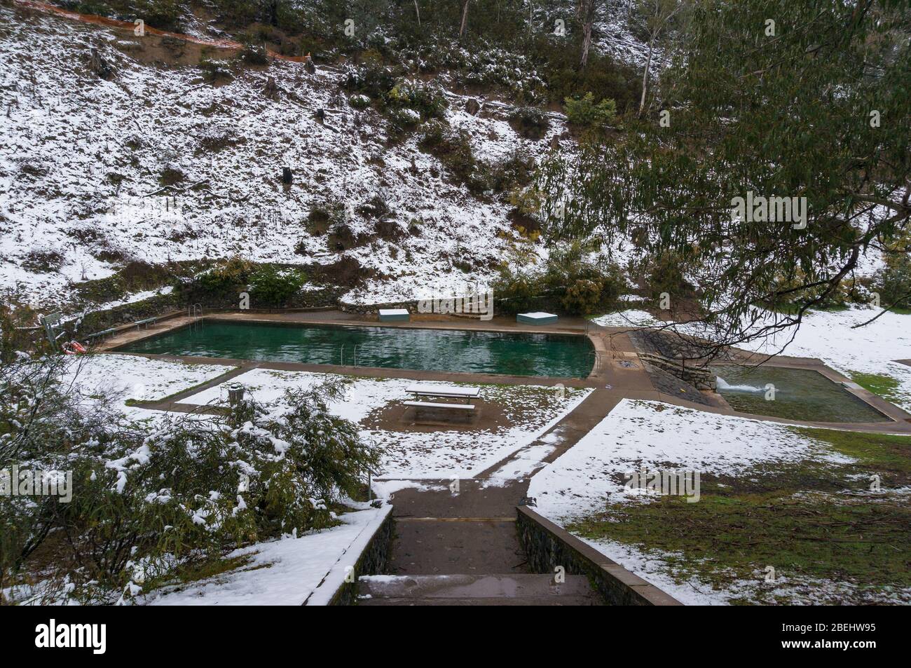 Outdoor swimming pool with winter landscape and snow. Yarrongobilly hot ...