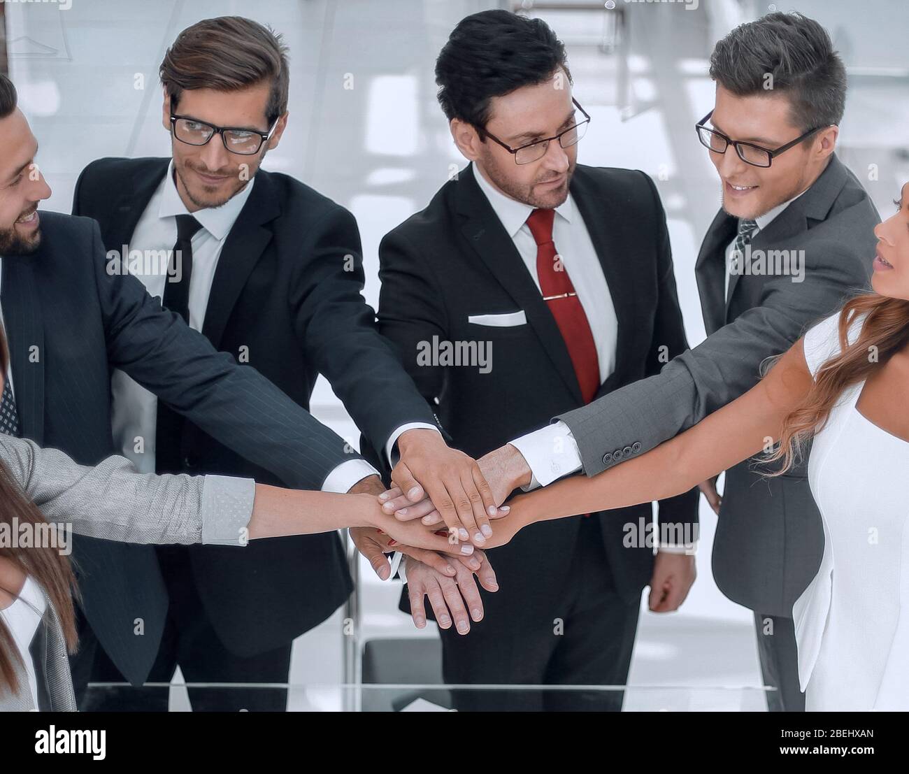 group of young business people showing their unity Stock Photo - Alamy