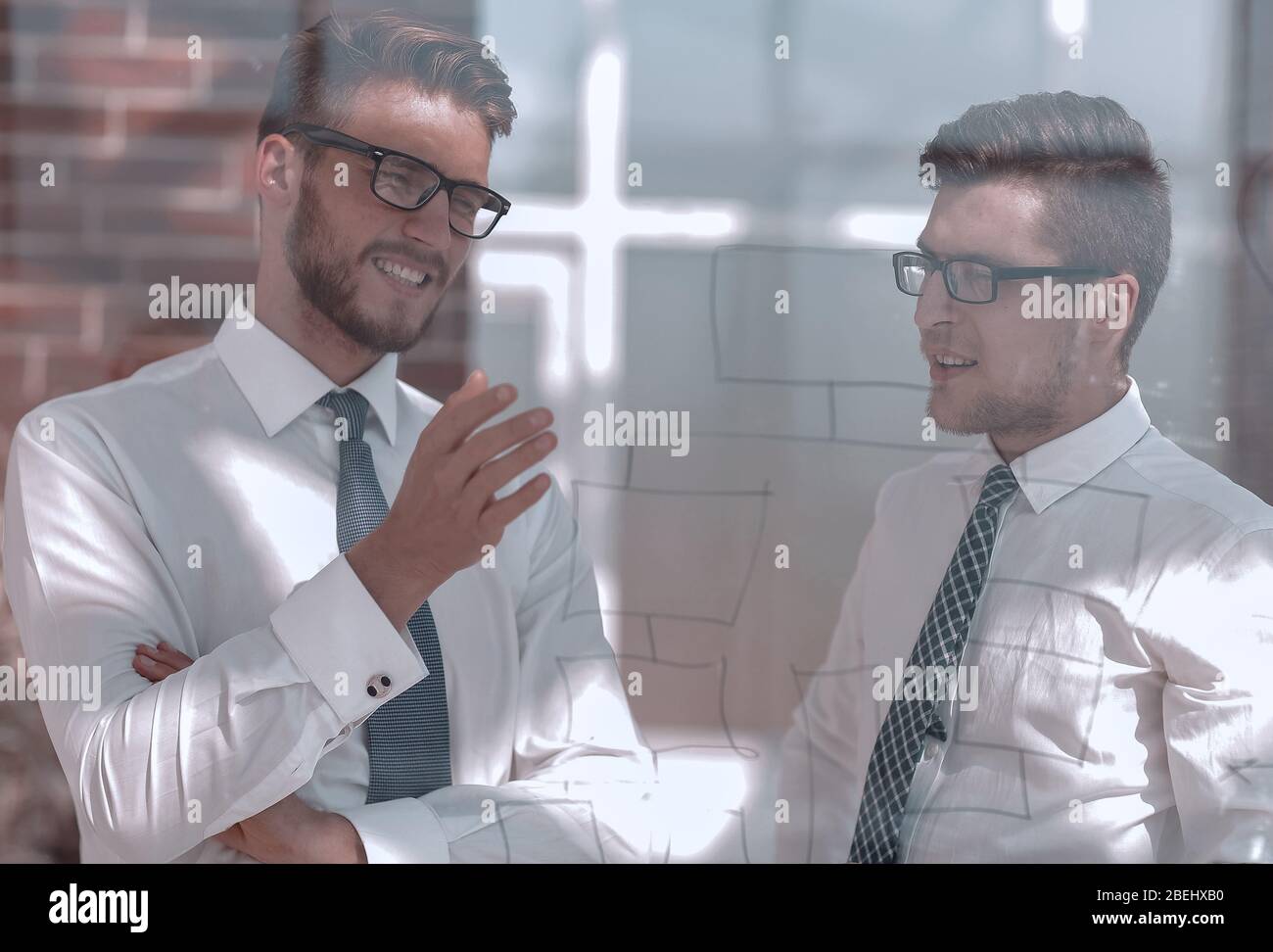 close up.two employees talking standing in the office Stock Photo - Alamy
