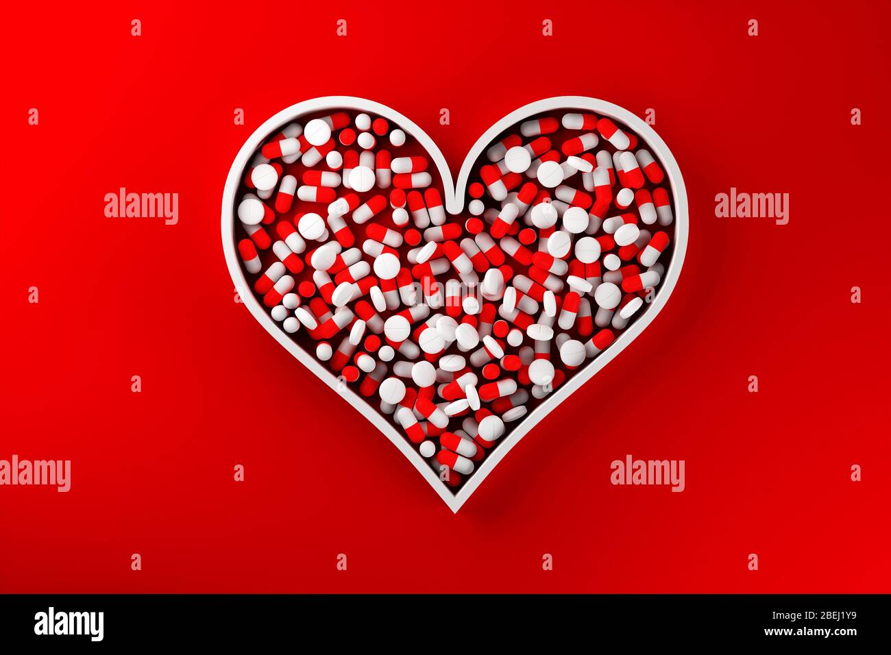 Heart shape filled with red pill capsules over red background - heart ...