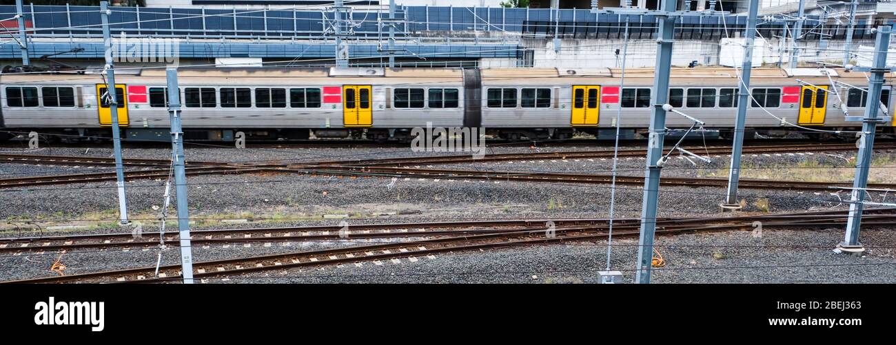 Criss-crossing heavy rail train tracks on gravel in the city with a ...