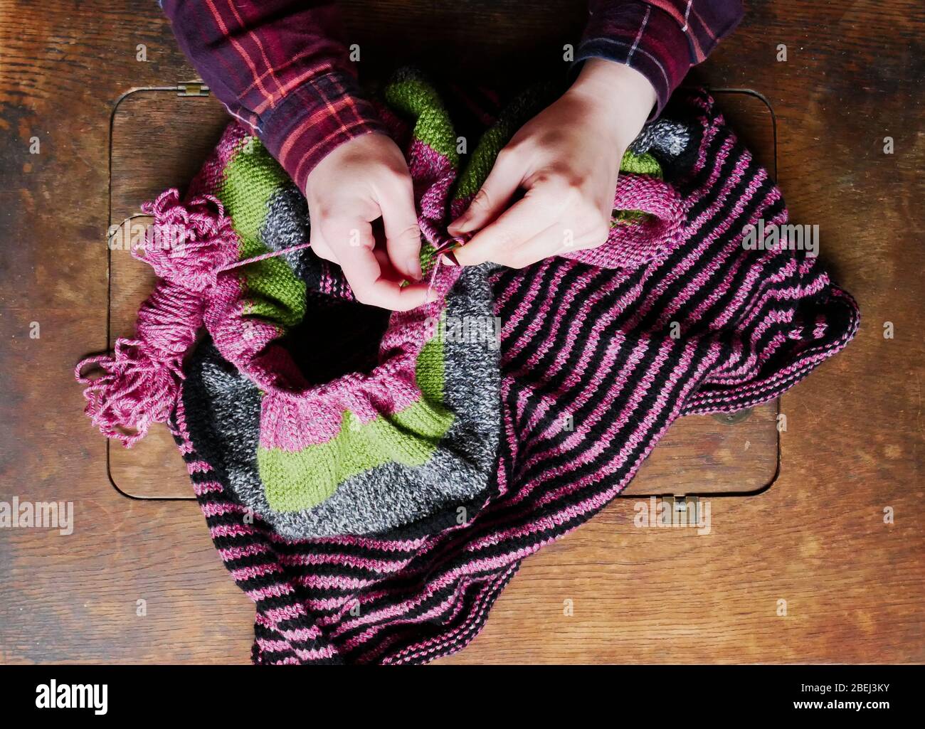 Top view of person knitting on an old wooden desk Stock Photo - Alamy