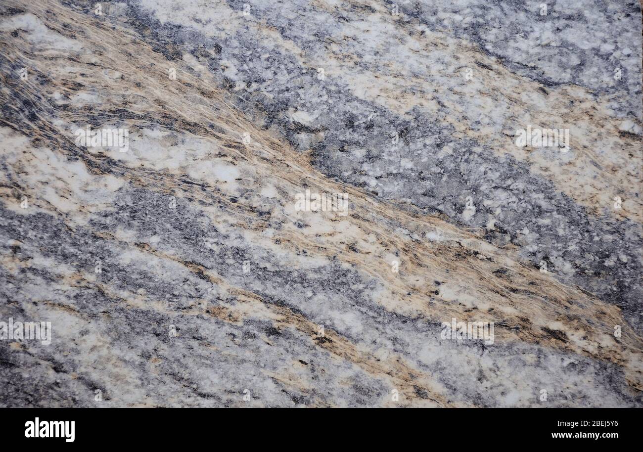 Dark gray granite with streaks and blots of brown and white. Background ...