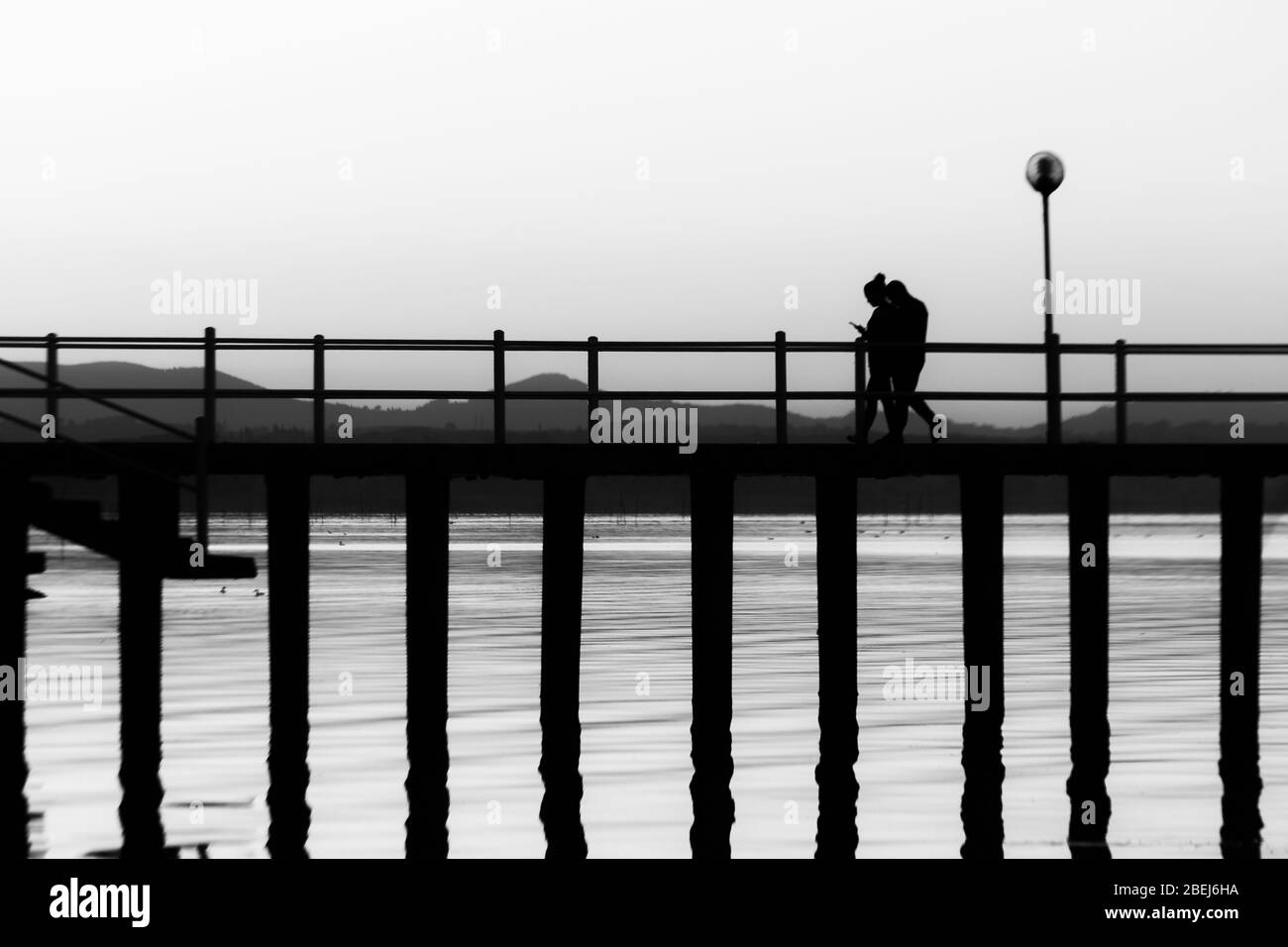 Two people on sunrise Black and White Stock Photos & Images - Alamy