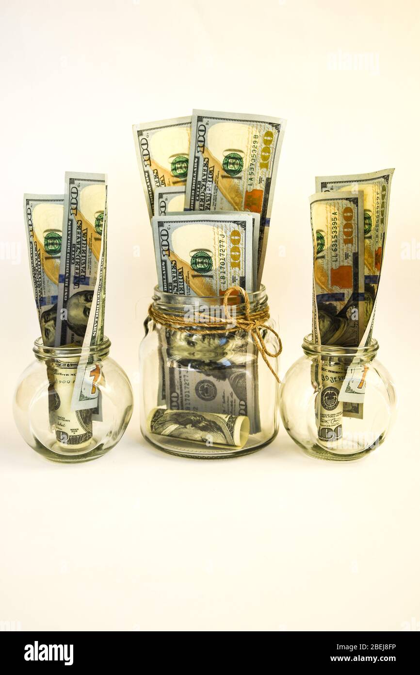 Glass jars filled with dollar bills, savings inside glass jar, money ...