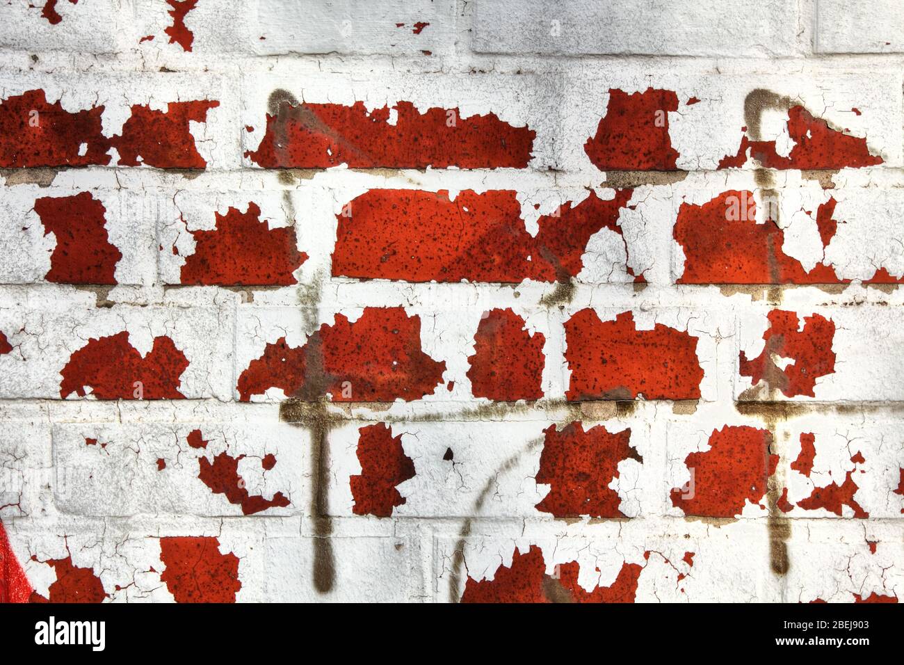 Wall of red bricks with rest of white color Stock Photo - Alamy