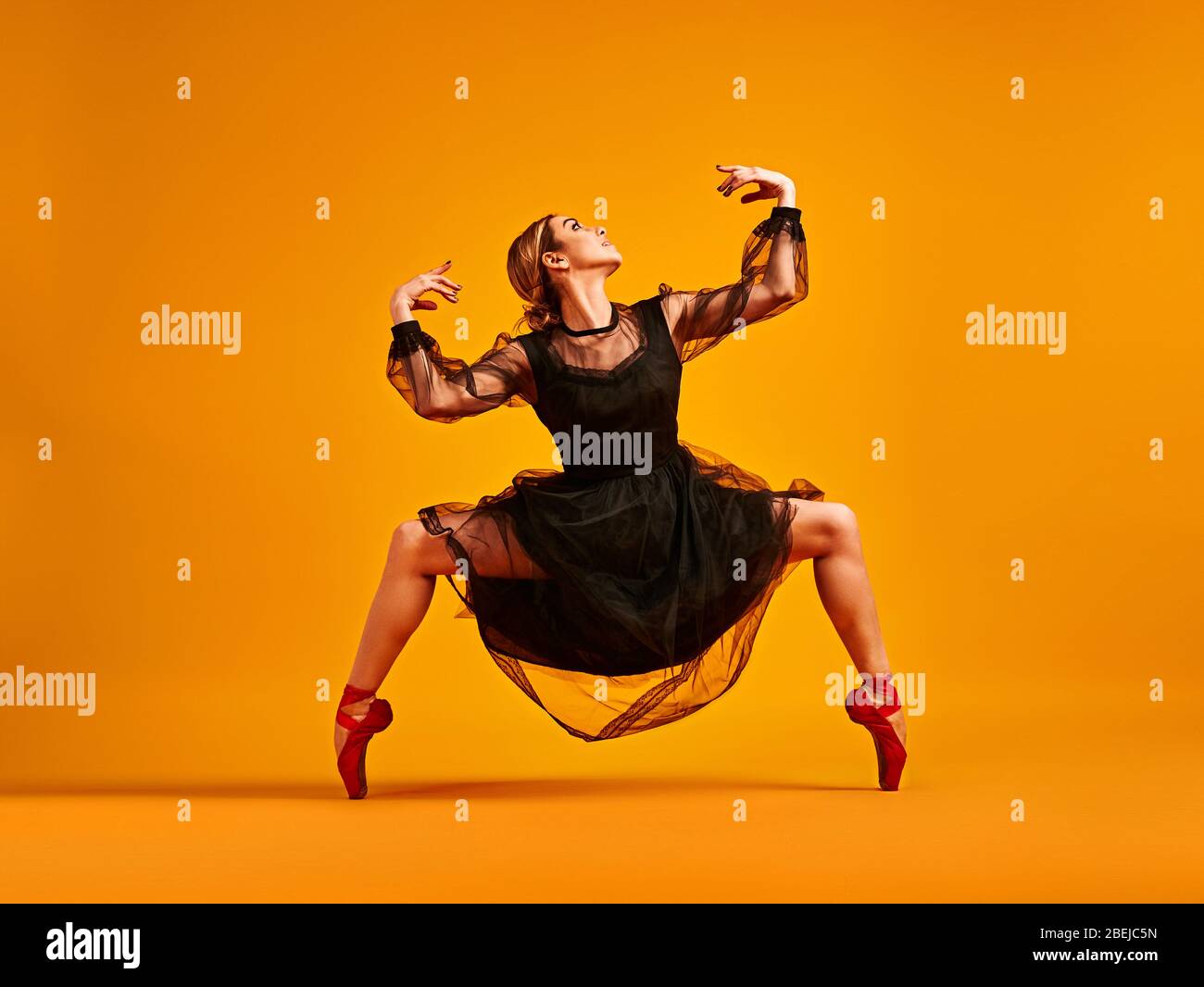 Ballet dancer or classic ballerina dancing isolated on yellow ...