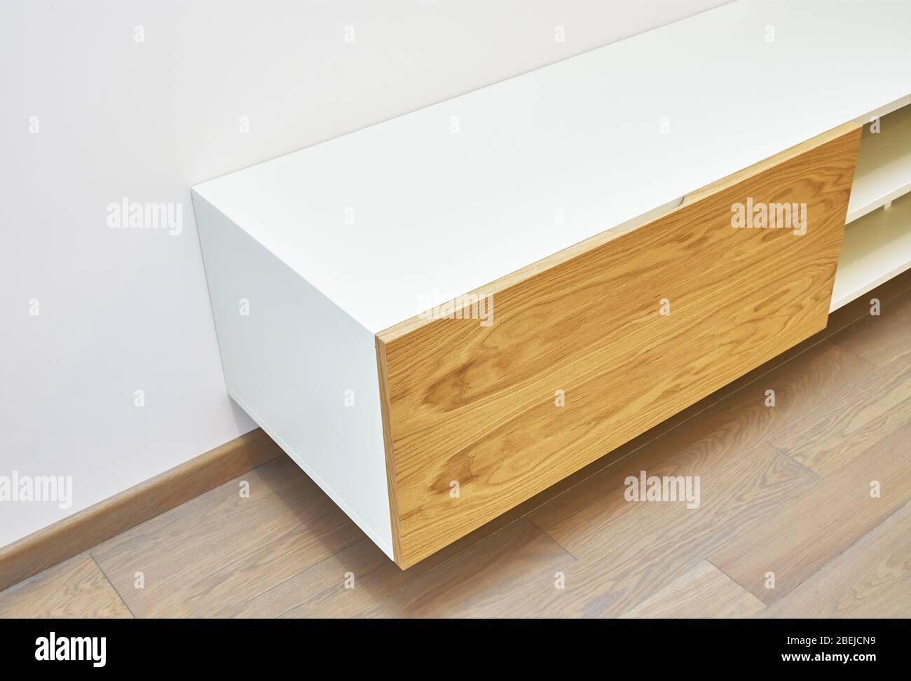 Contemporary floating media cabinet in living room. Wooden wall mounted ...