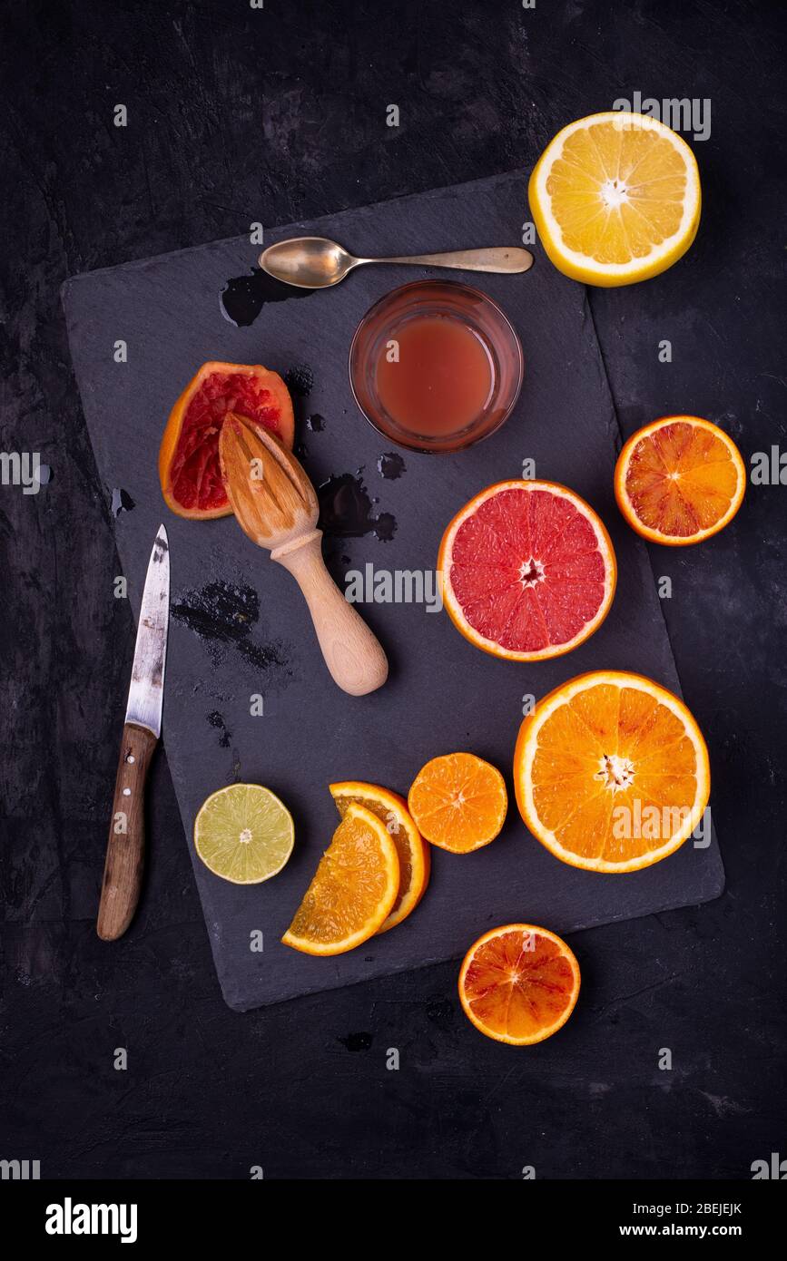 on the slate slab, with a top view, sliced citrus fruits, and freshly ... on the slate slab, with a top view, sliced citrus fruits, and freshly ...