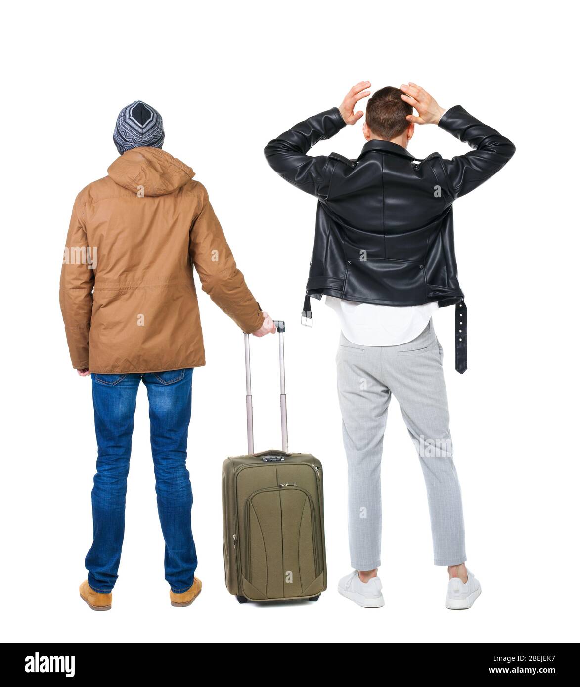 Back view of two man in winter jacket traveling with suitcas. Back view ...