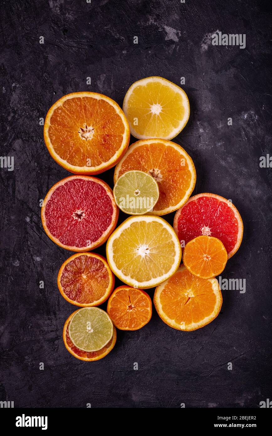 top view of various types of citrus fruits, cut into slices and laid on ...