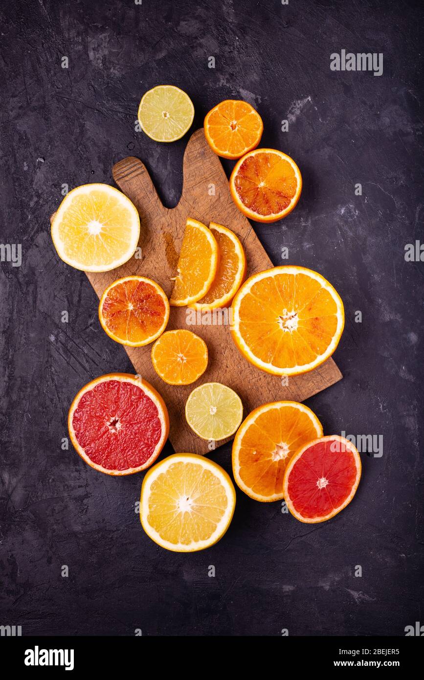 top view of various types of citrus fruits, cut into slices and laid on ...