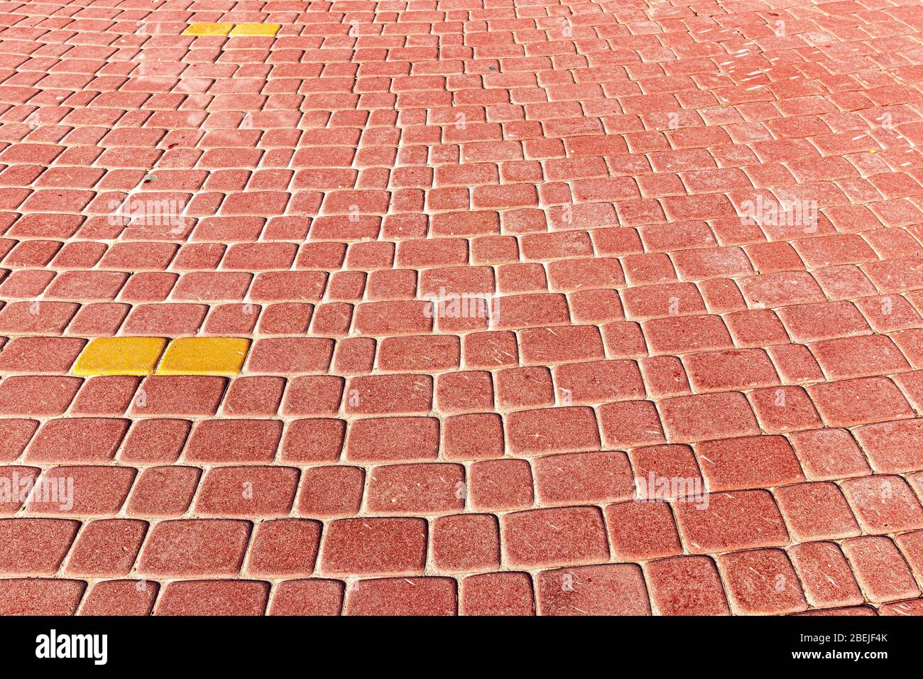 Top view on red paving stone road. Old pavement of granite texture ...