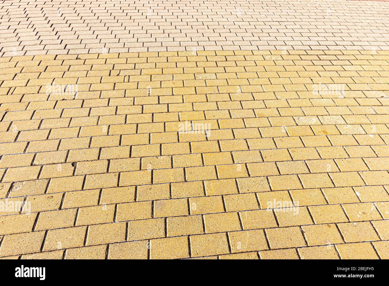 Top view on orange paving stone road. Old pavement of granite texture ...