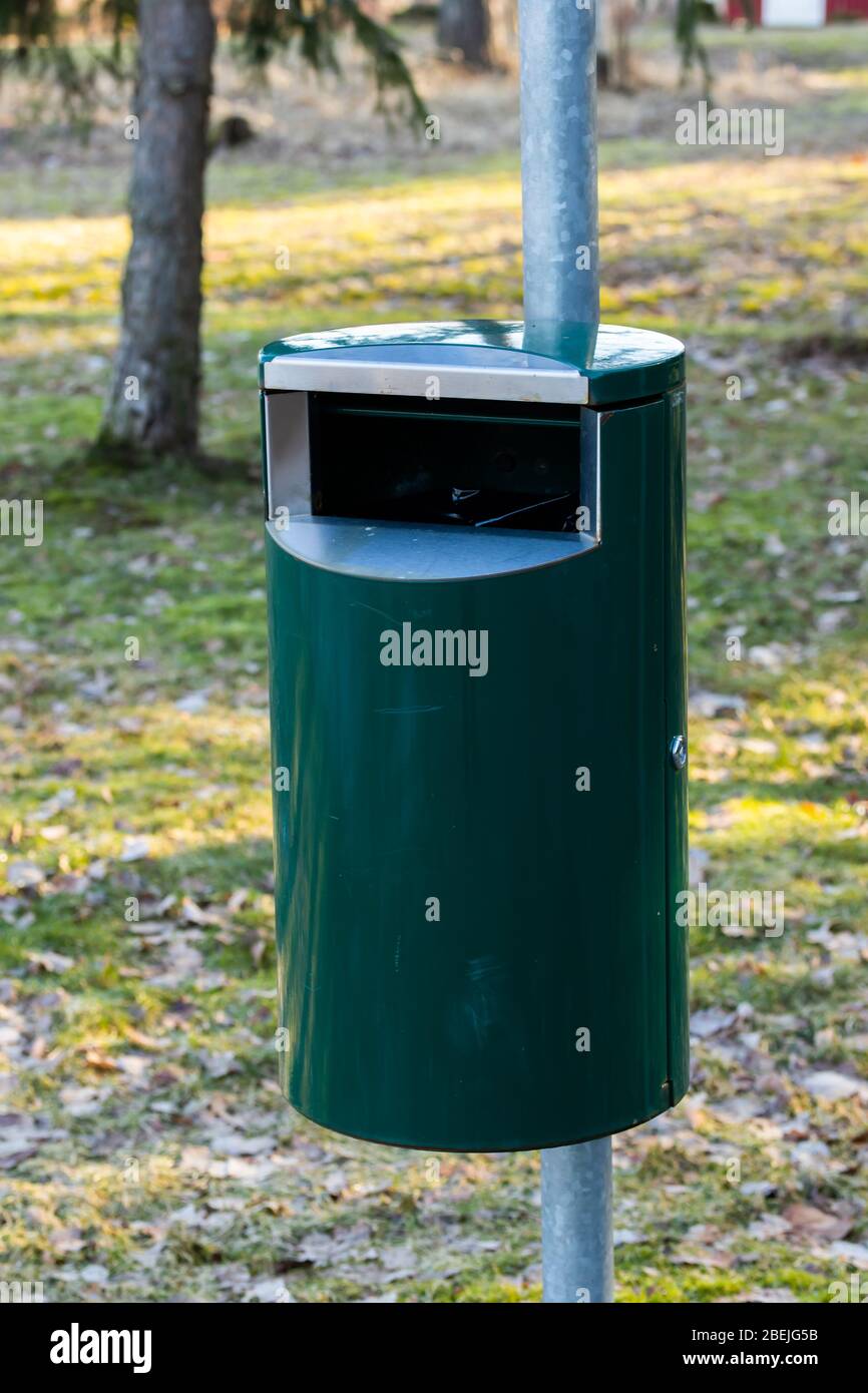 Green metal trash can in a park in Finland Stock Photo - Alamy