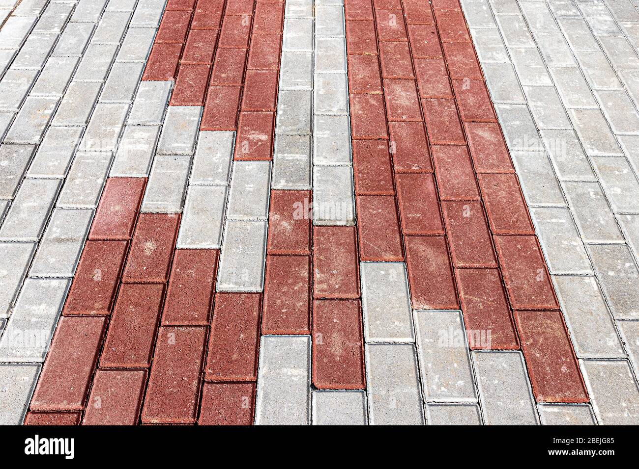 Top view on red and gray paving stone road. Old pavement of granite ...