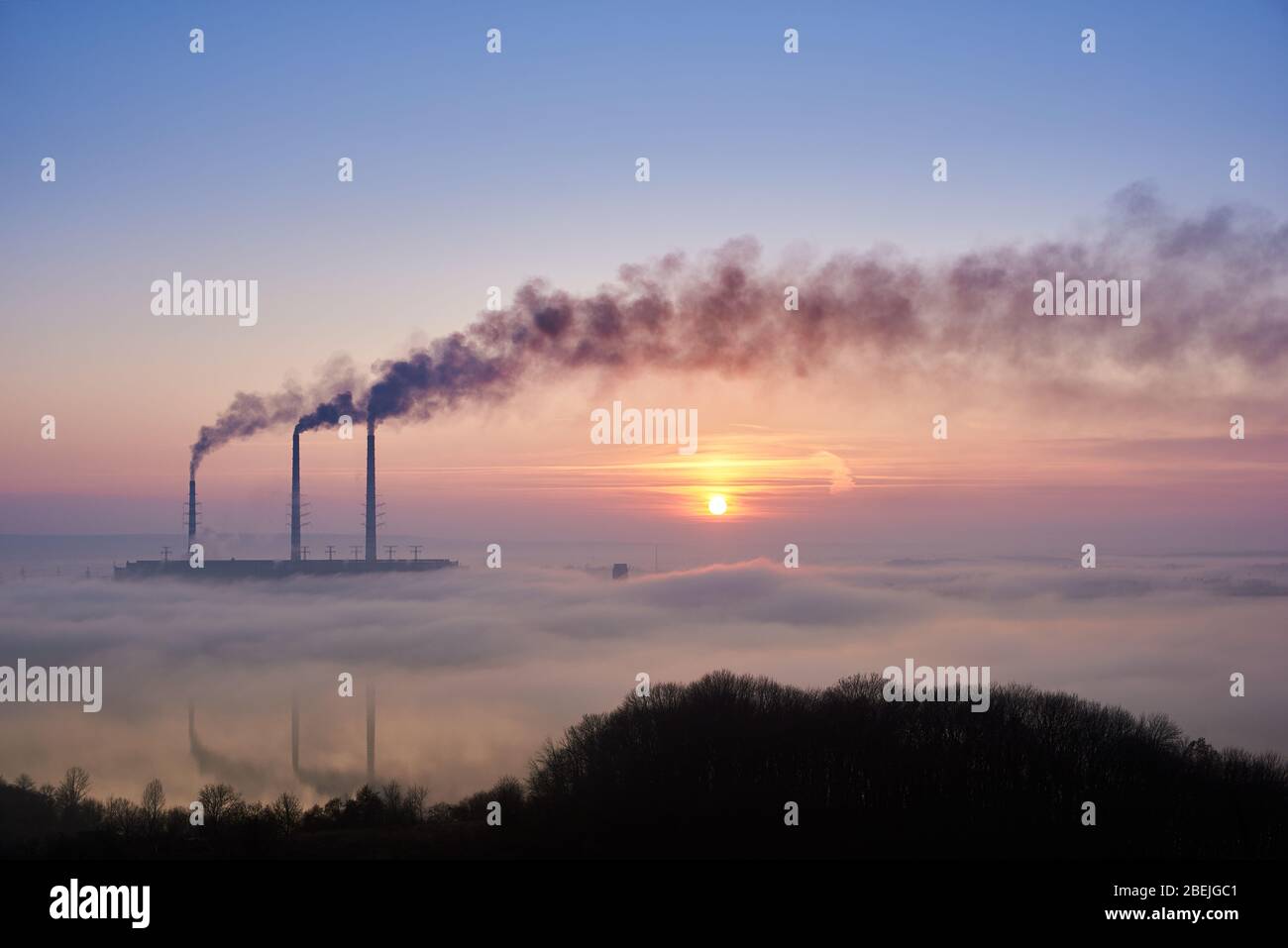 Colorful blue and pink sky with bright rising sun at thermoelectric ...