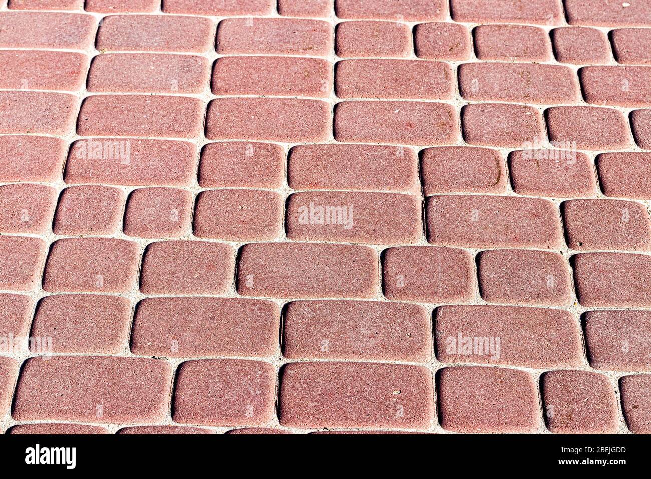 Top view on red paving stone road. Old pavement of granite texture ...