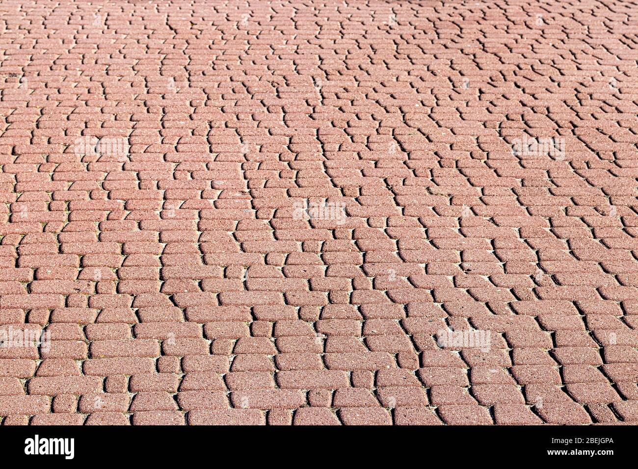 Top view on red paving stone road. Old pavement of granite texture ...