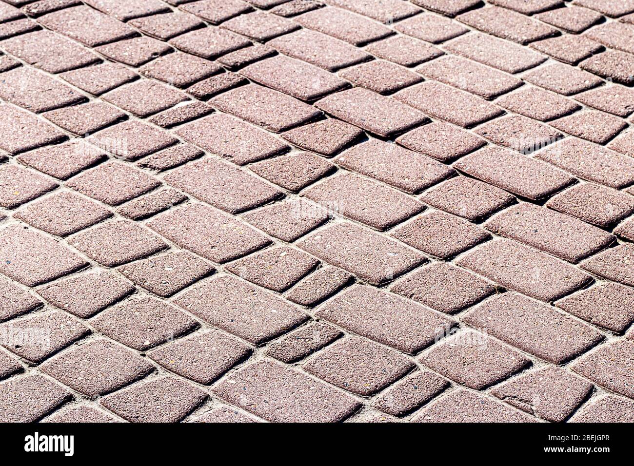 Top view on red paving stone road. Old pavement of granite texture ...