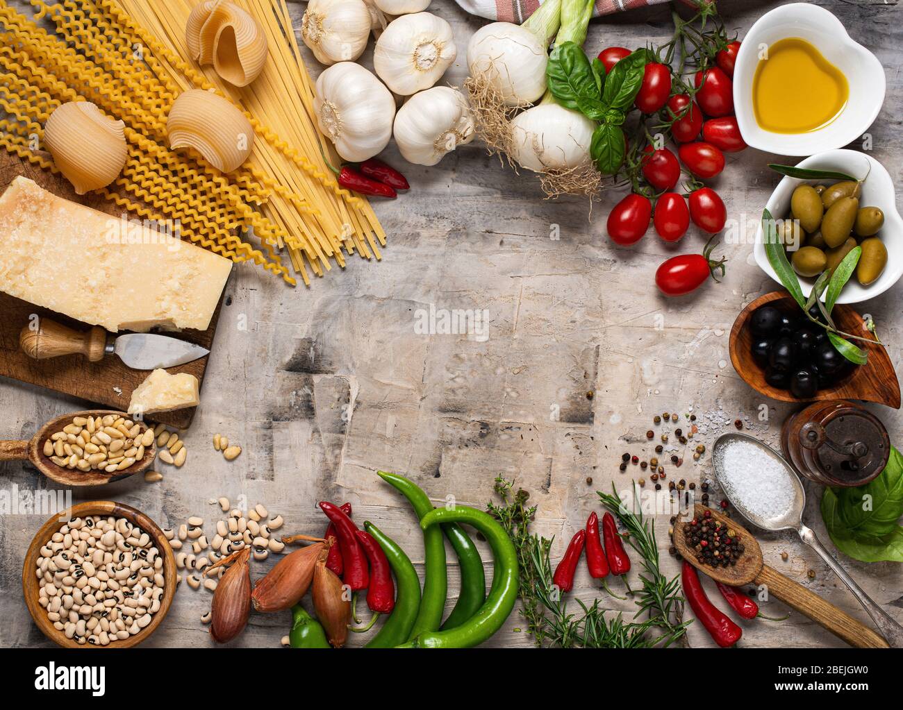 top view, on a dark rustic background, raw pasta and traditional ...