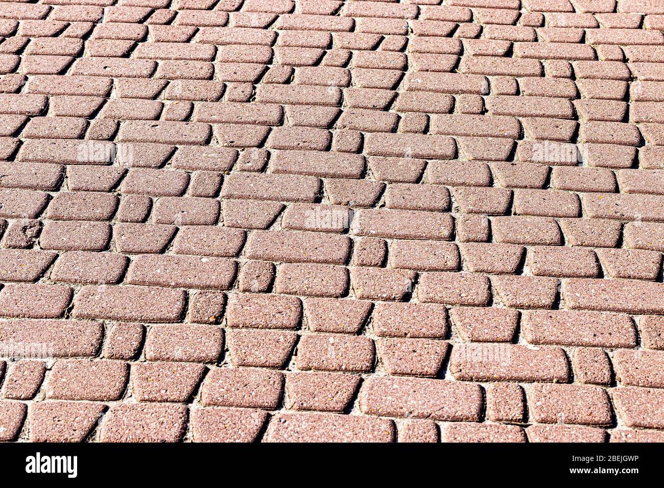 Top view on red paving stone road. Old pavement of granite texture ...