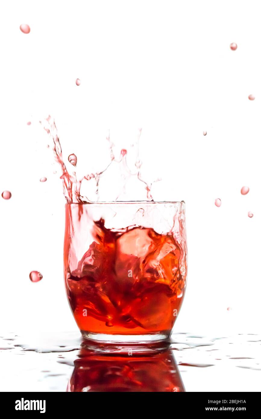 Red liquid squash with white background Stock Photo - Alamy