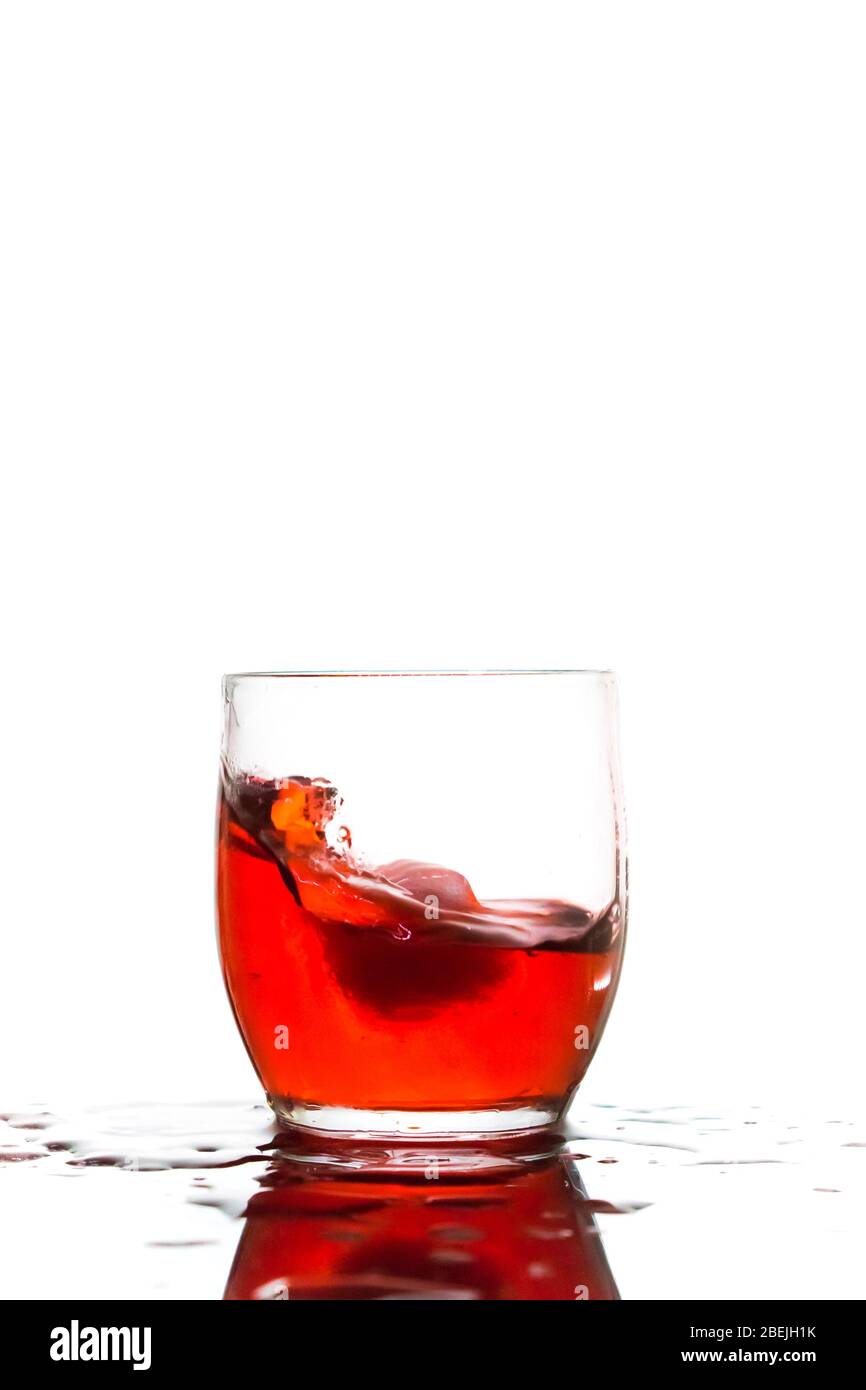 Red liquid squash with white background Stock Photo - Alamy