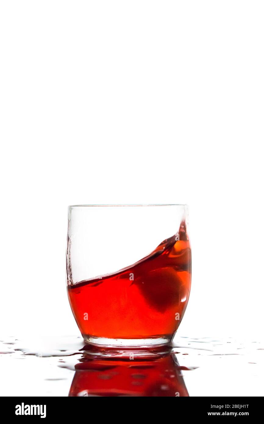Red liquid squash with white background Stock Photo - Alamy