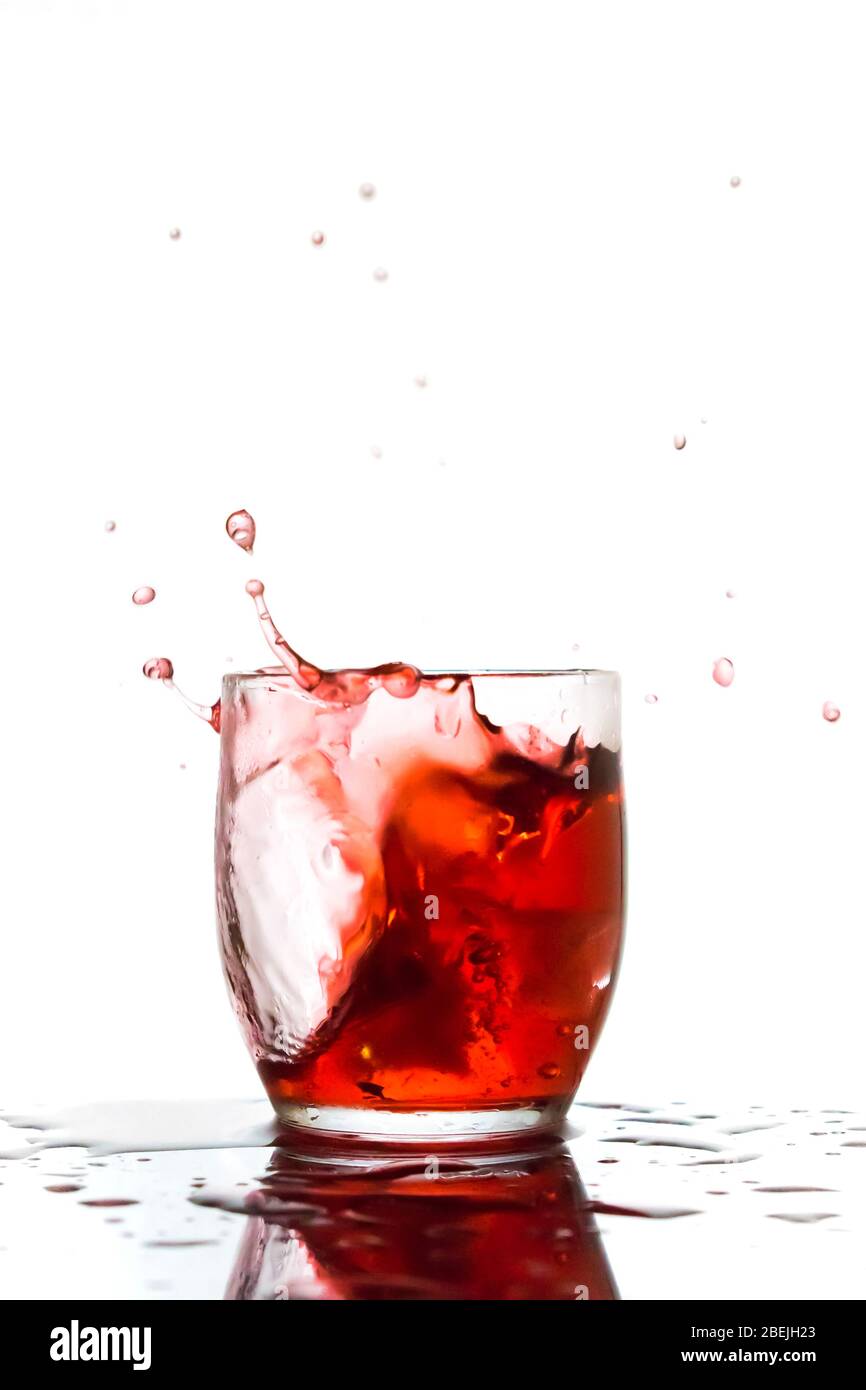 Red liquid squash with white background Stock Photo - Alamy