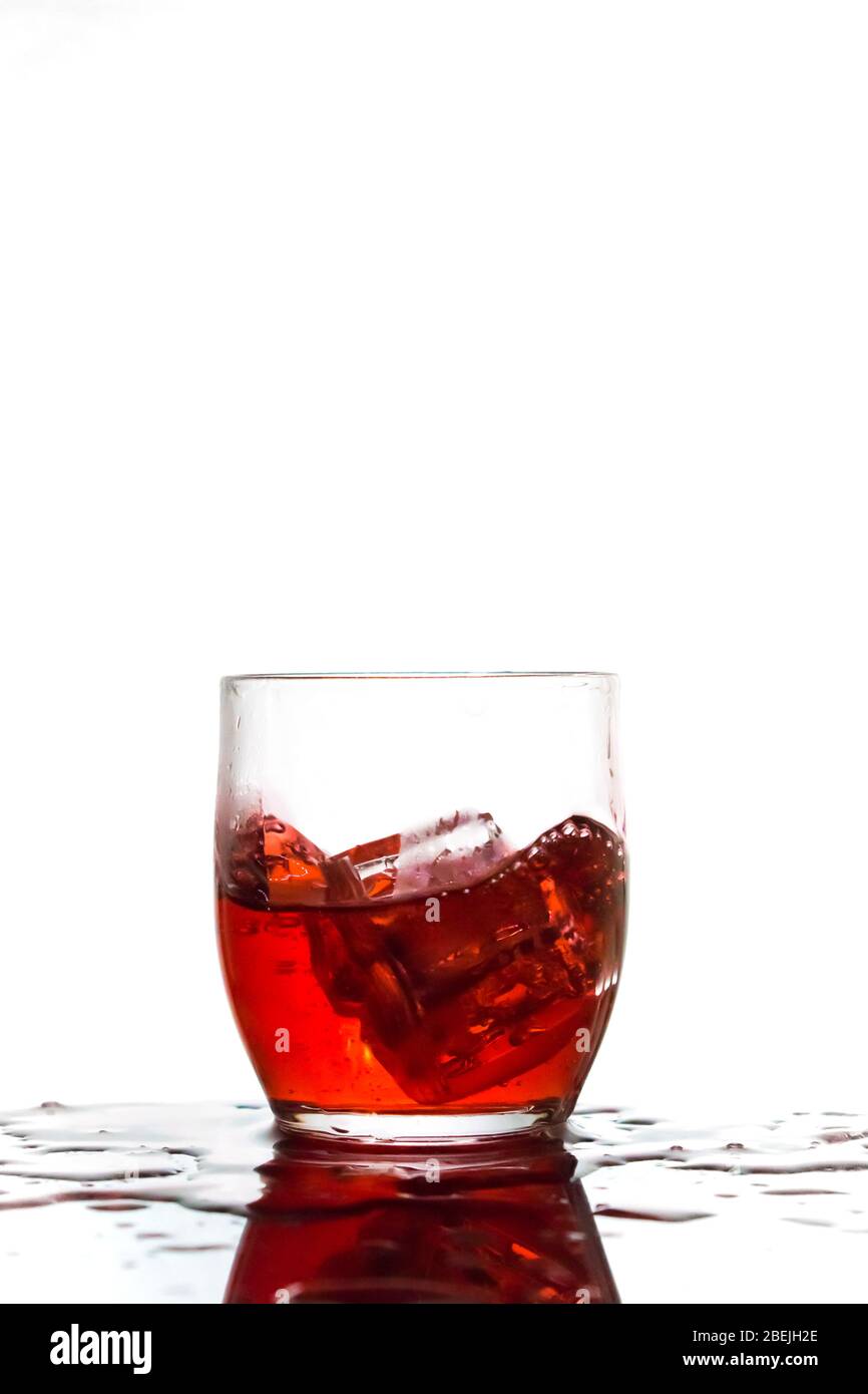 Red liquid squash with white background Stock Photo - Alamy