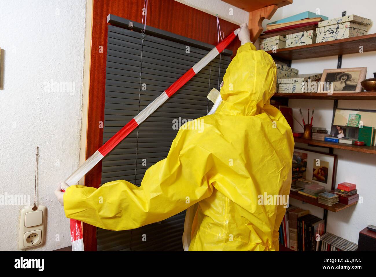 Woman in a full protective suit secures with a barrier tape Stock Photo ...