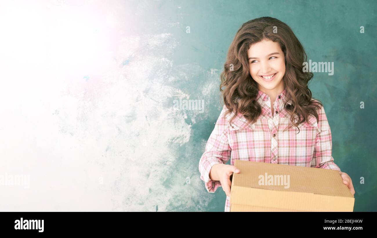 Young girl with delivery box. Happy child relocation stuff. Holding ...