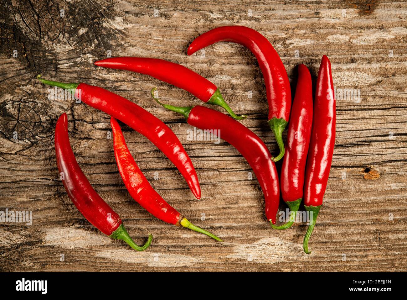 red and spicy chillies on the rough wooden table, with top view Stock ...