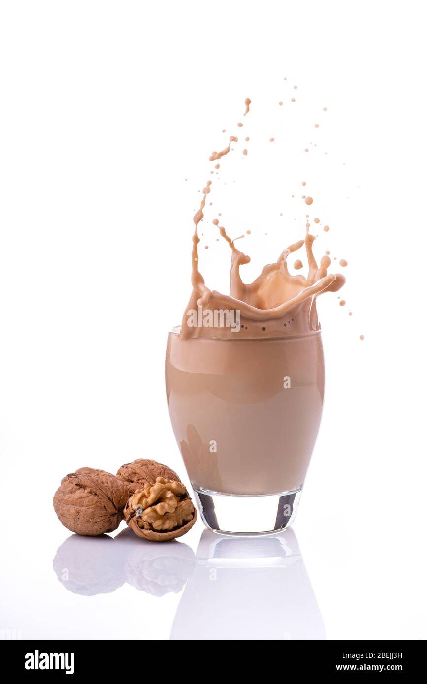 in the glass, isolated from the white background, a vegetable drink of ...
