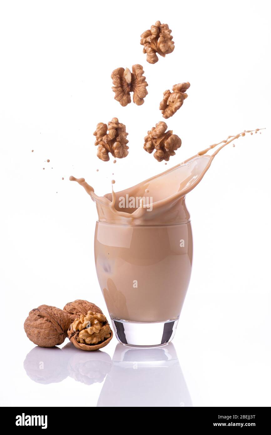 in the glass, isolated from the white background, a vegetable drink of ...